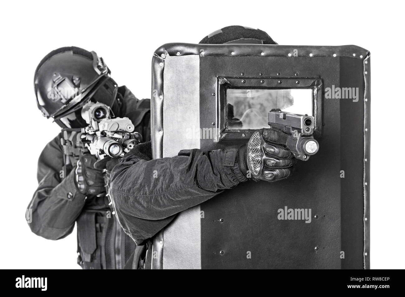 Studio shot of SWAT police special forces hiding behind ballistic ...