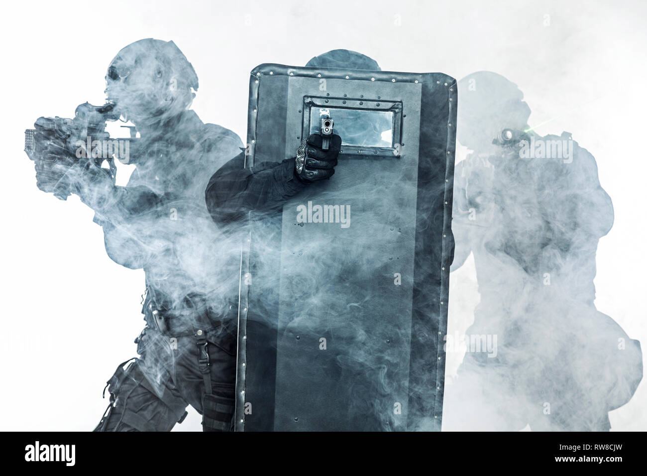 SWAT police special forces hiding behind ballistic shield and smoke ...