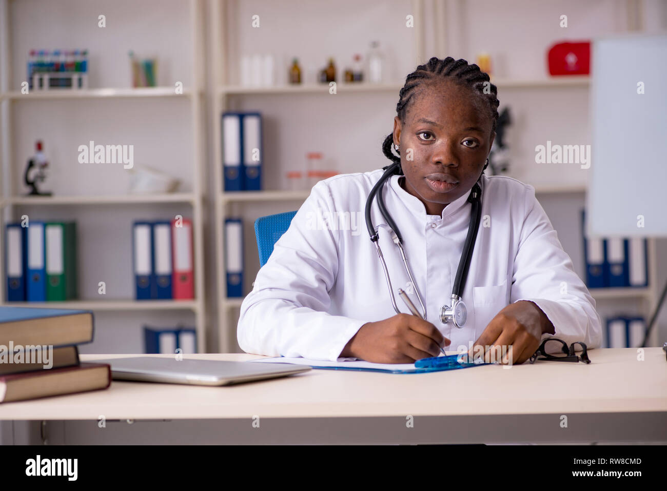 Black female doctor working at clinic Stock Photo - Alamy