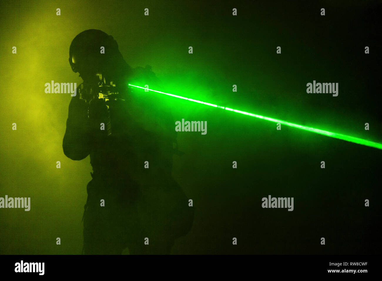 Studio shot of SWAT police operator with laser sights on rifle Stock ...