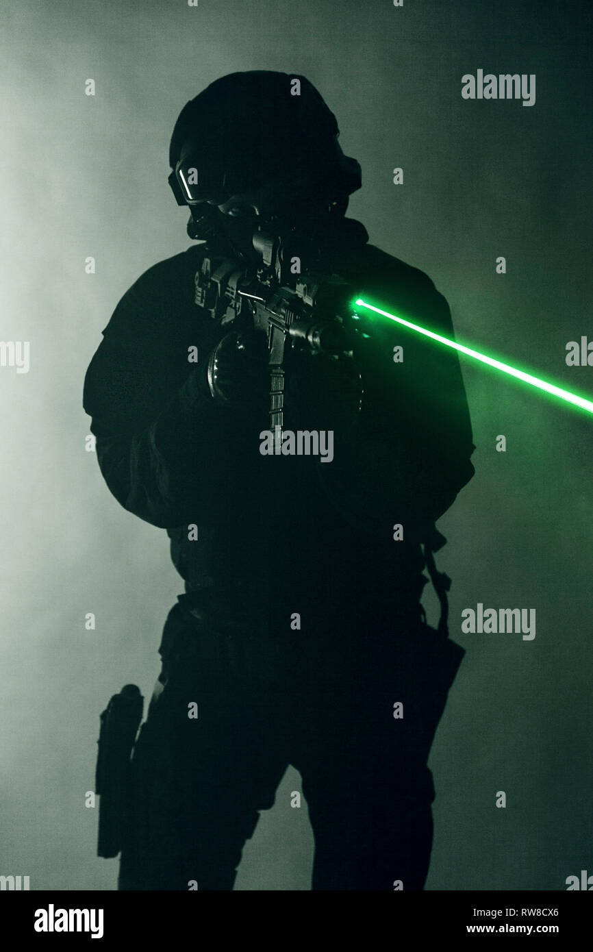 Studio shot of SWAT police operator with laser sights on rifle Stock ...