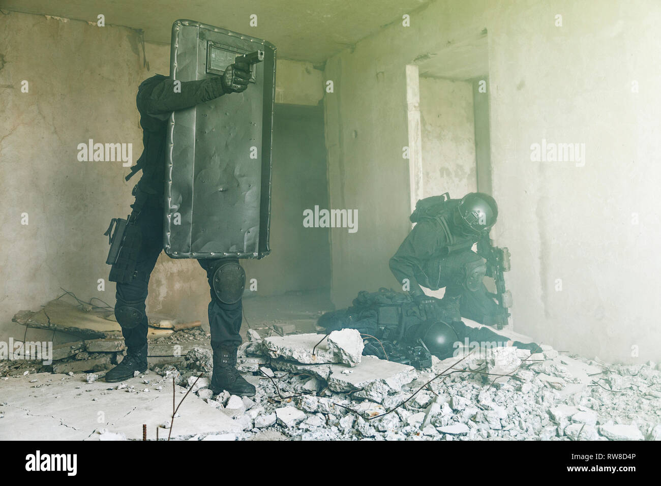 Squad of SWAT police special forces hiding behind ballistic shield in a ...