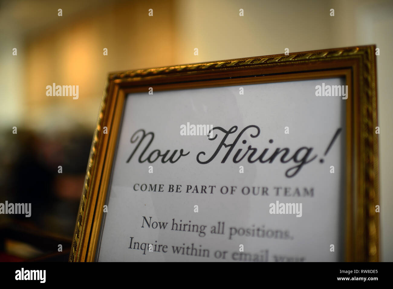 Now Hiring sign inside a business Stock Photo - Alamy