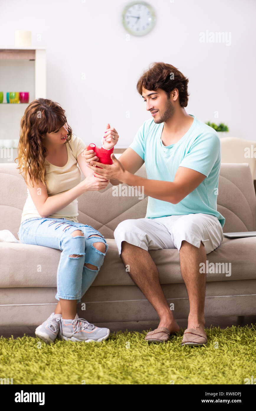Young family helping each other after injury Stock Photo - Alamy