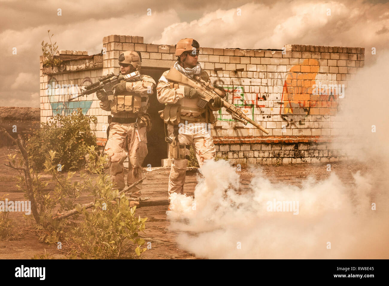 Navy SEALs Team with weapons in action Stock Photo - Alamy