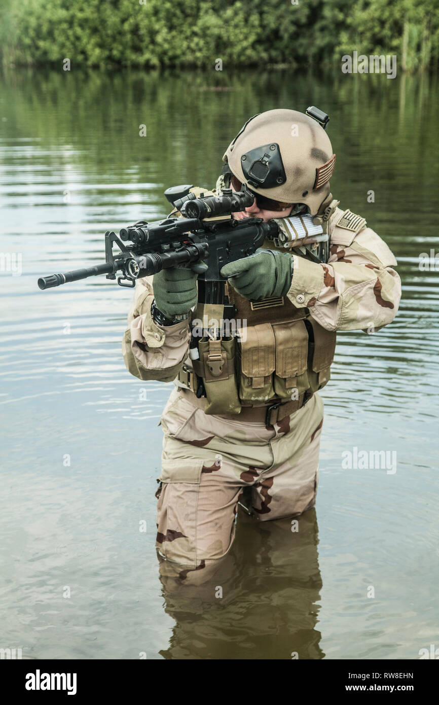 Member of Navy SEAL Team crossing the river with weapons Stock Photo ...