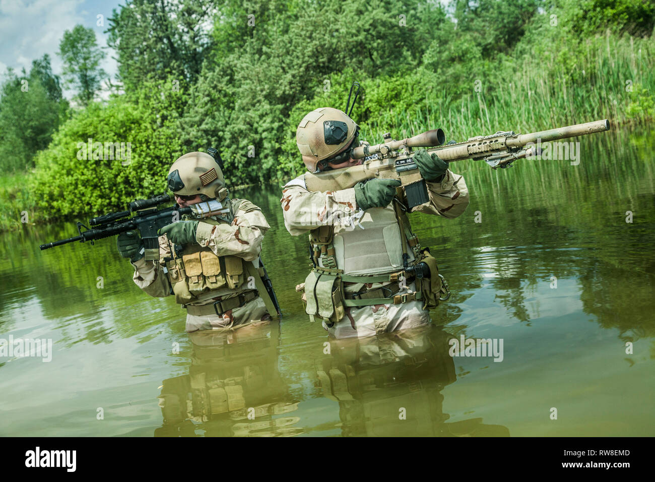 Navy SEALs crossing the river with weapons Stock Photo - Alamy