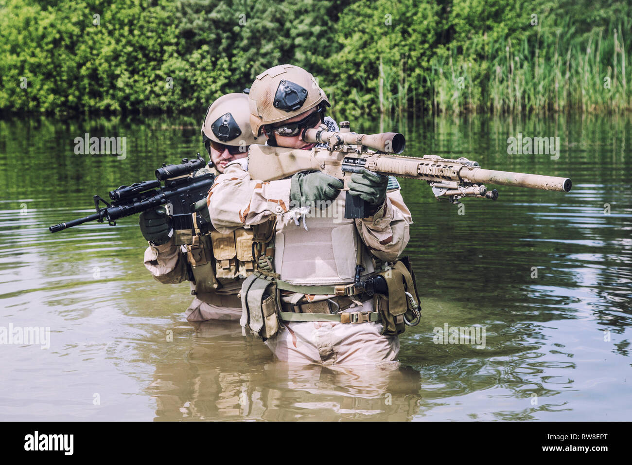 Navy SEALs crossing the river with weapons Stock Photo - Alamy