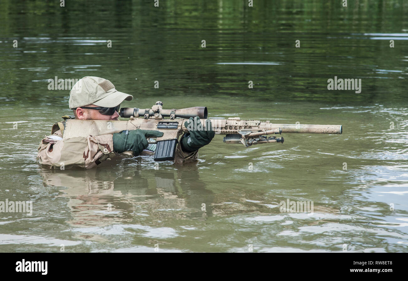 Member of Navy SEAL Team crossing the river with weapons Stock Photo ...