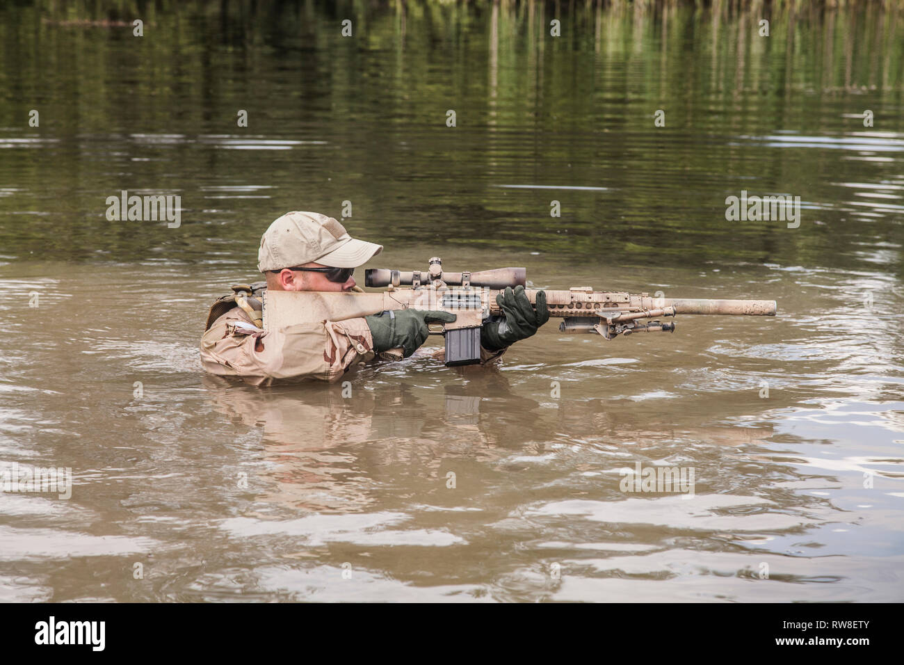 Member of Navy SEAL Team crossing the river with weapons Stock Photo ...