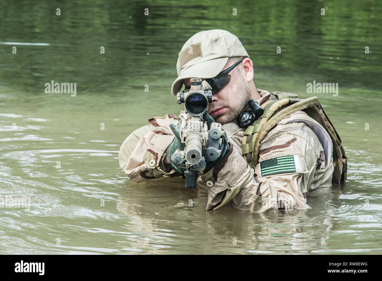 Member of Navy SEAL Team crossing the river with weapons Stock Photo ...