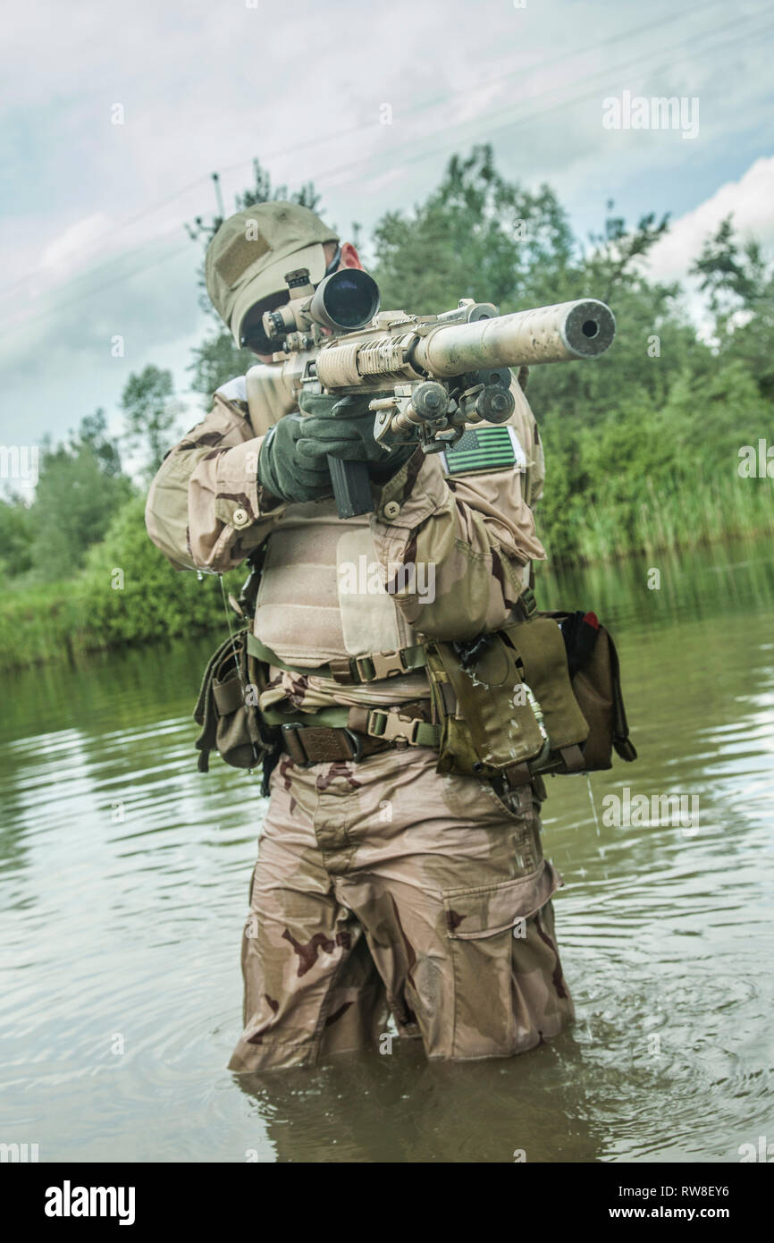Member of Navy SEAL Team crossing the river with weapons Stock Photo ...
