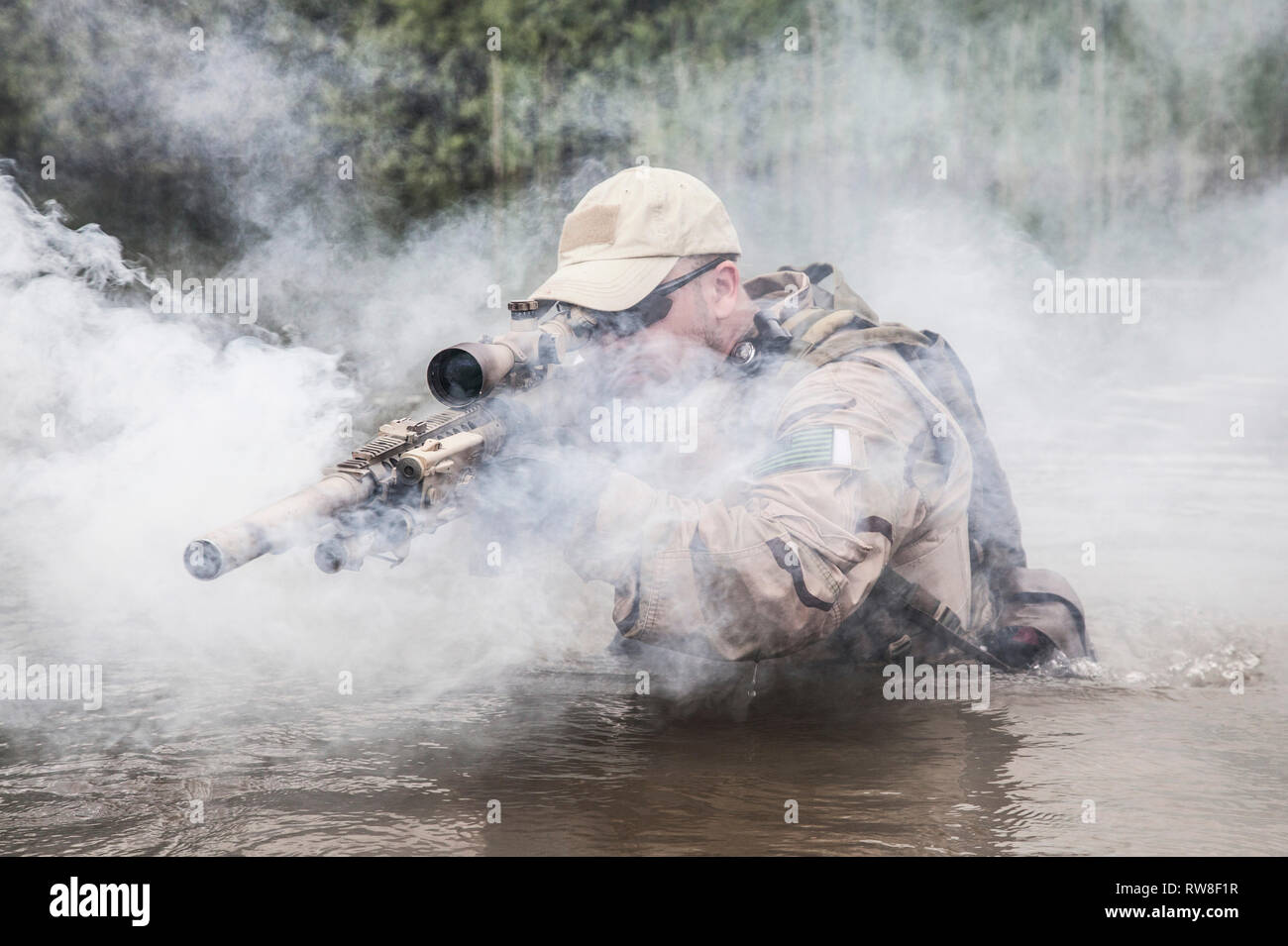 Member of Navy SEAL Team crossing the river with weapons Stock Photo ...