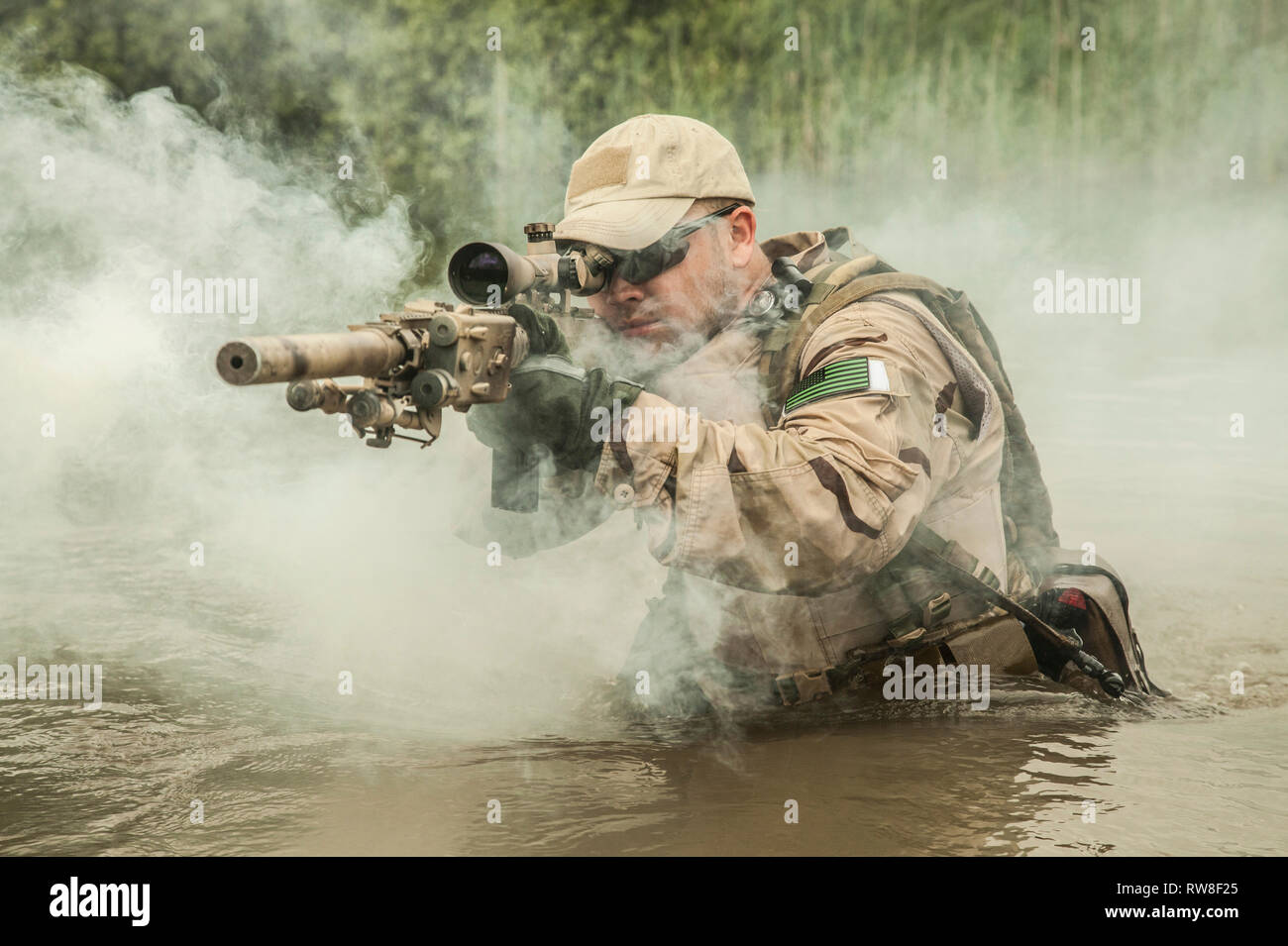 Member of Navy SEAL Team crossing the river with weapons Stock Photo ...