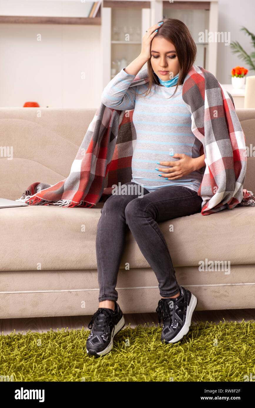 Sick pregnant woman suffering at home Stock Photo - Alamy
