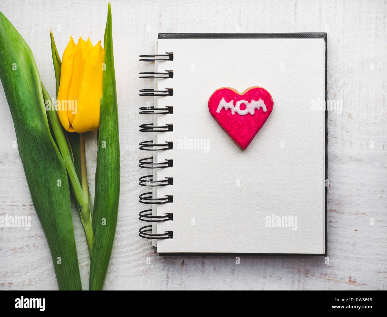 Beautiful greeting card with the word MOM. Blank page, bright tulip and ...