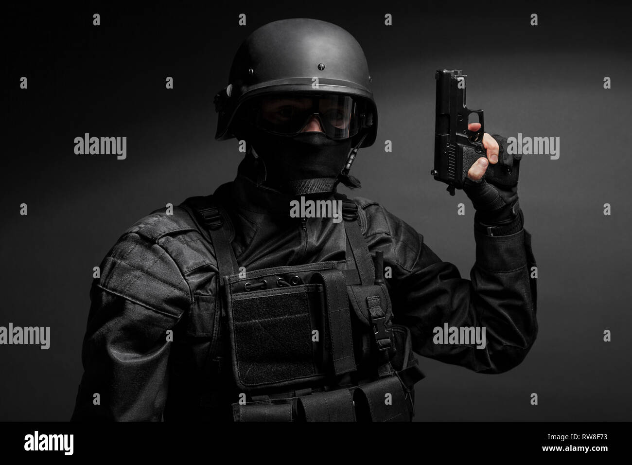 Spec ops police officer SWAT in black uniform with pistol Stock Photo ...