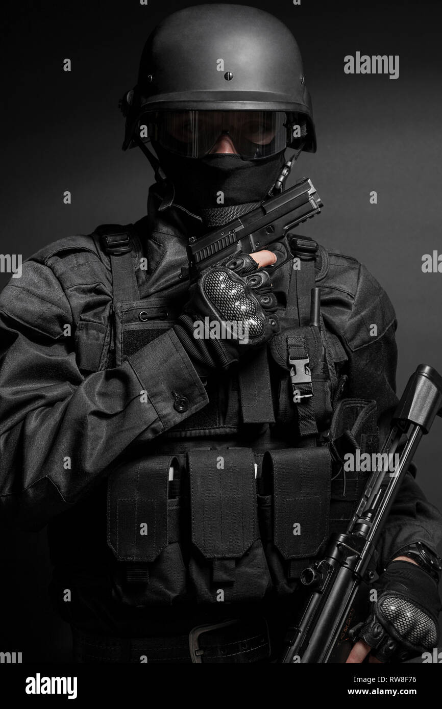 Spec ops police officer SWAT in black uniform with pistol Stock Photo ...