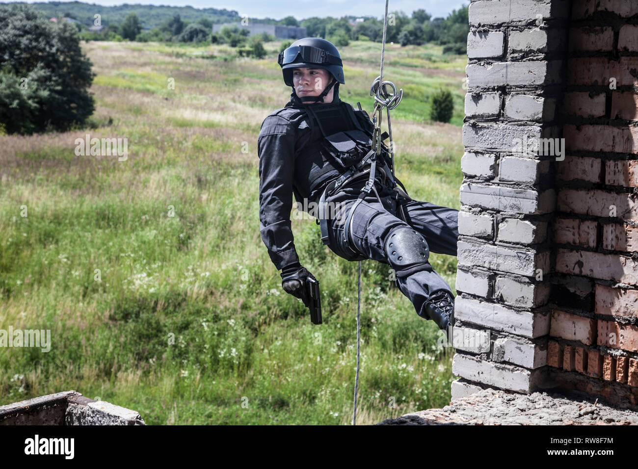Spec ops police officer SWAT during assault operation Stock Photo - Alamy