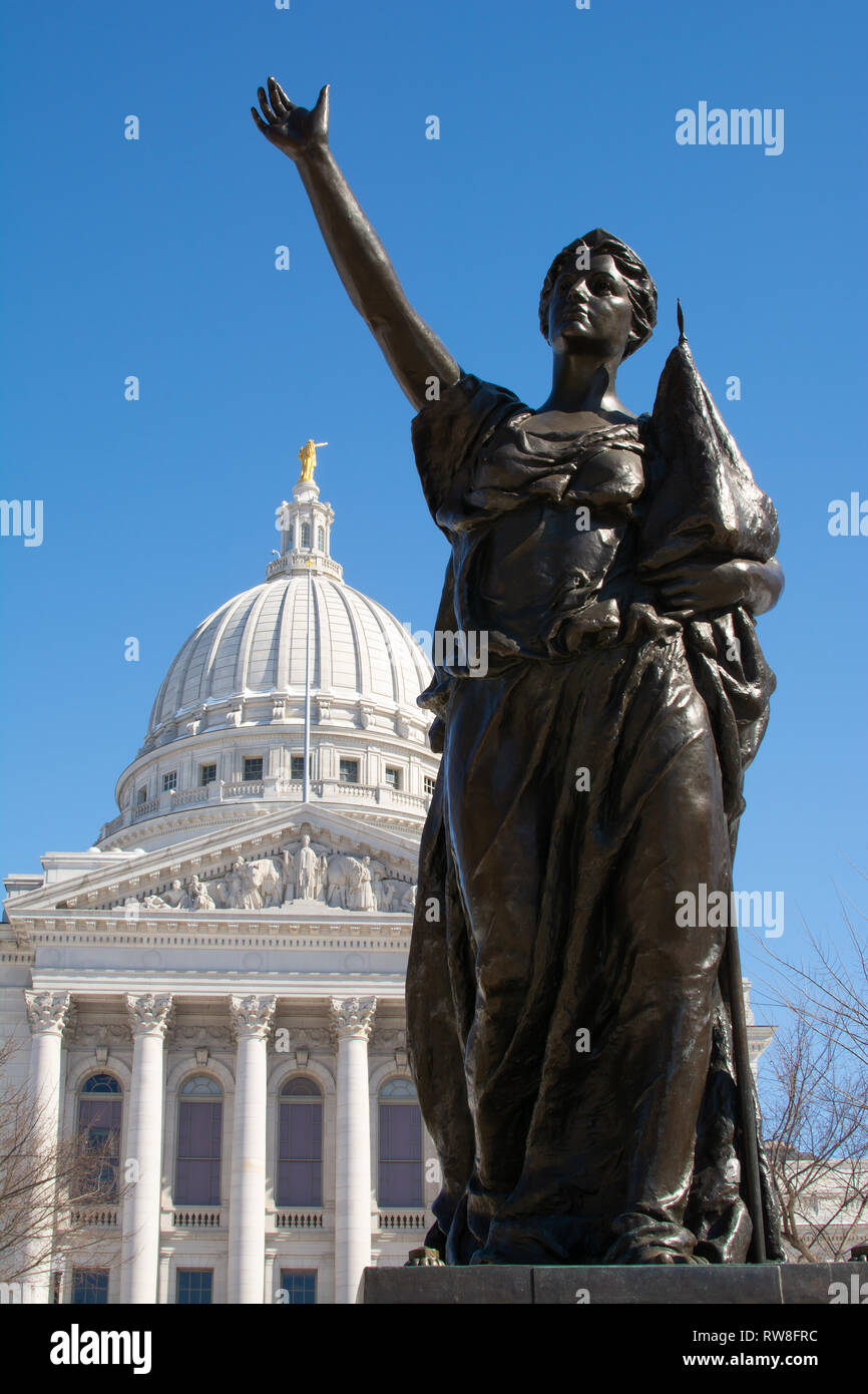 Statue with Wisconsin State Capital building in background. Madison ...