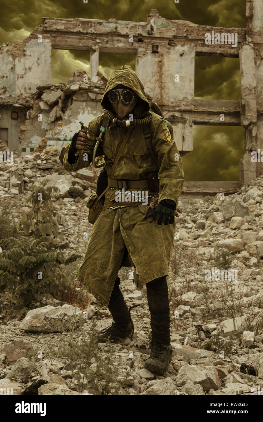 Post apocalypse survivor in tatters and gas mask on the ruins of a ...