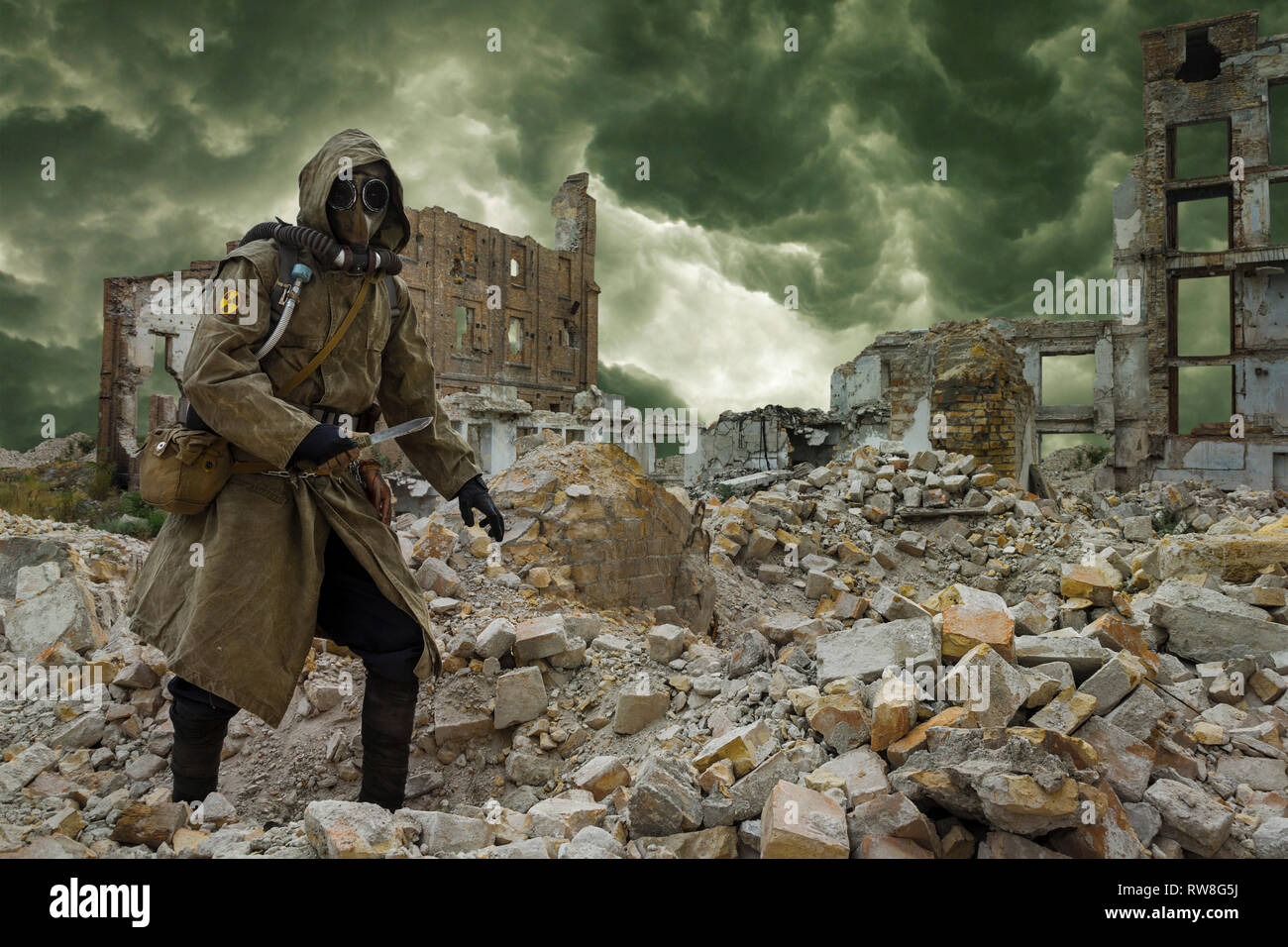 Post apocalypse survivor in tatters and gas mask on the ruins of a ...