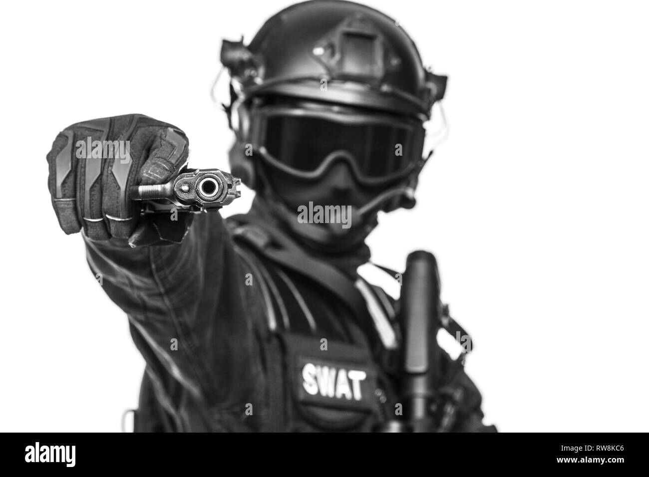 Spec ops police officer SWAT in black uniform and face mask, studio ...