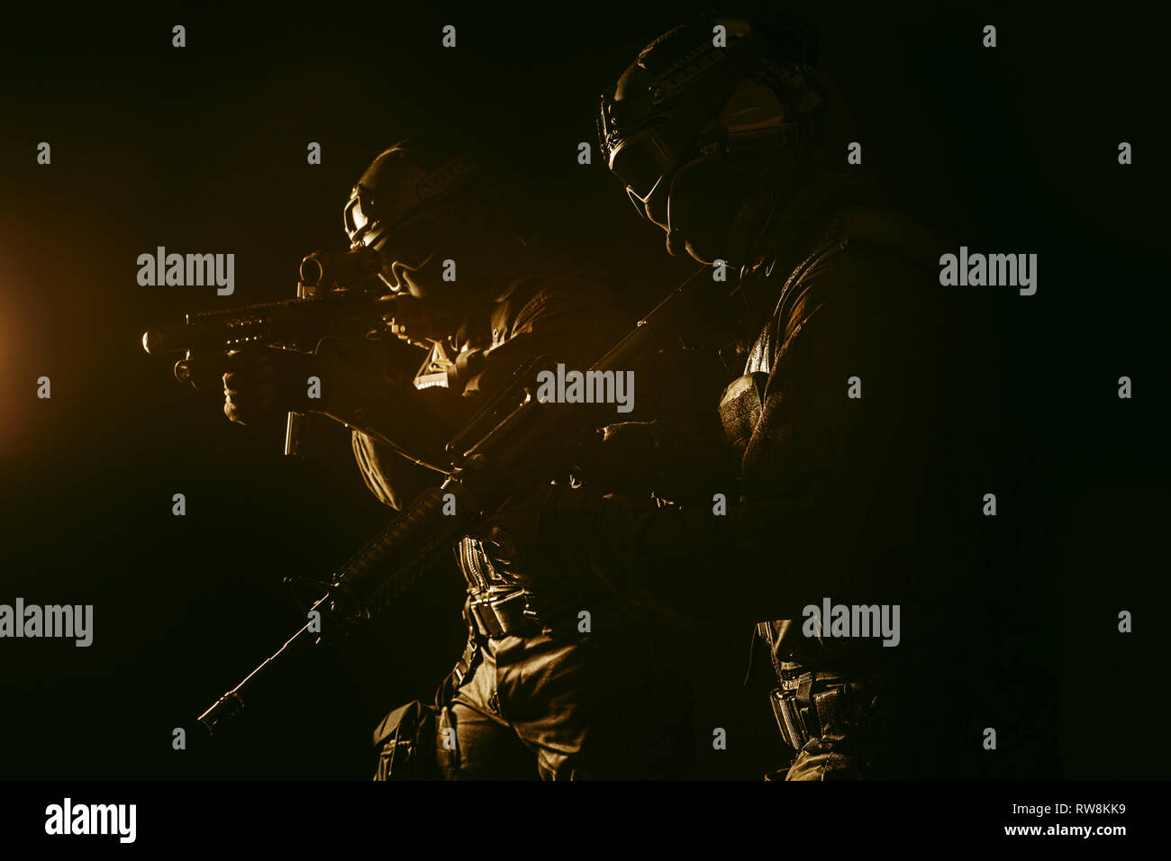 Spec ops police officers SWAT in black uniform and face mask, studio ...