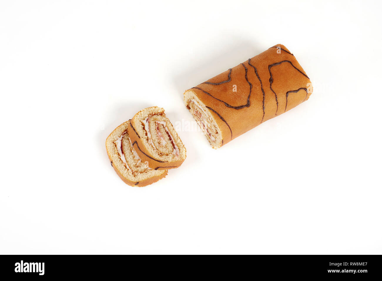 Biscuit roll cut into pieces, on a white background Stock Photo - Alamy