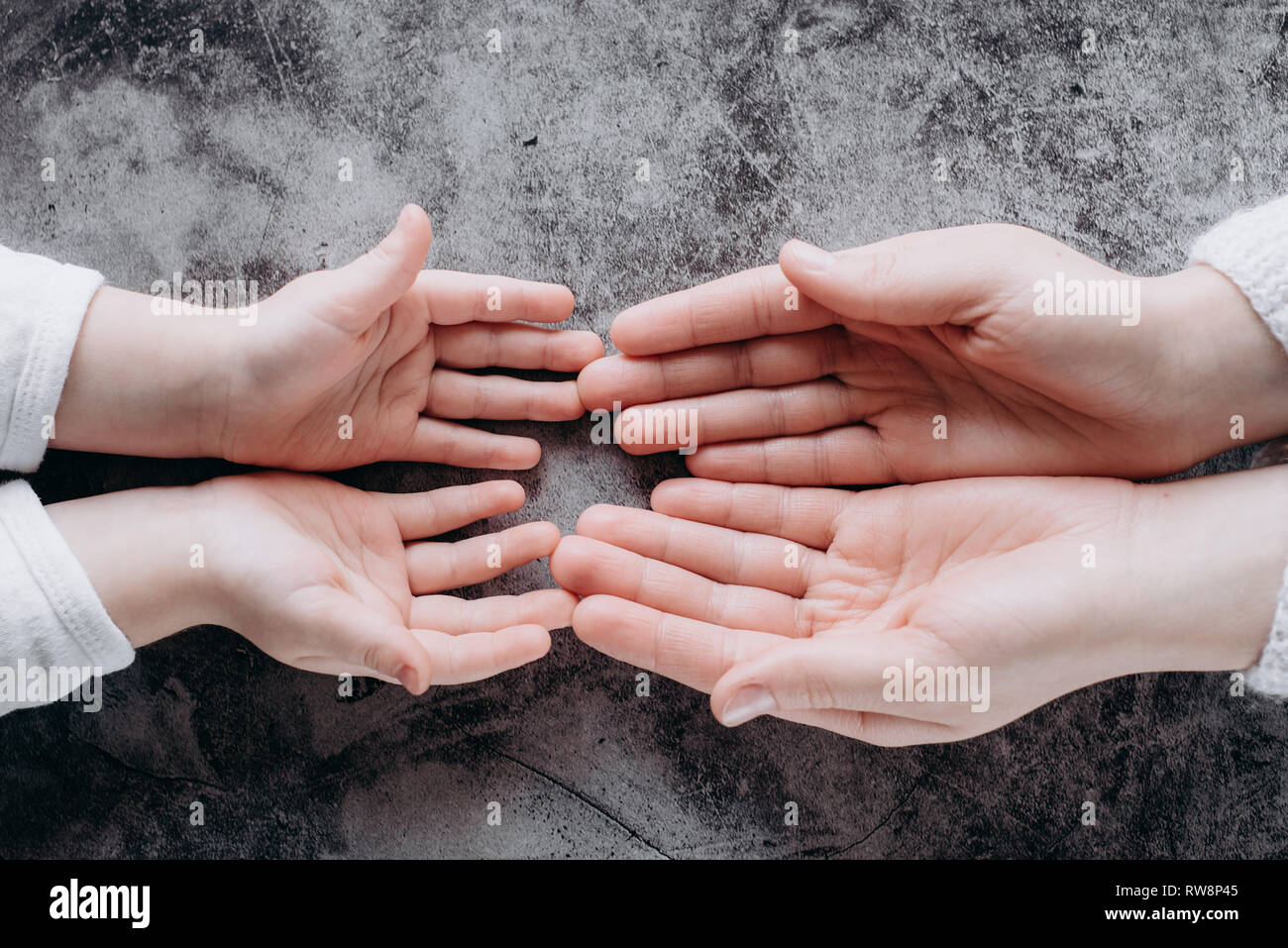 Close up view of family holding hands, loving caring mother supporting ...
