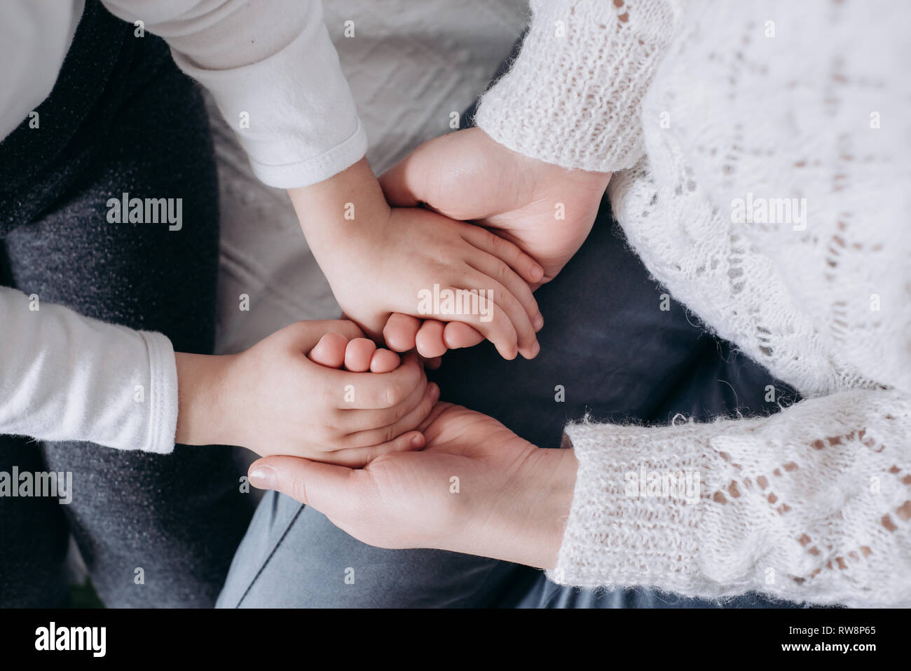 Close up view of family holding hands, loving caring mother supporting ...