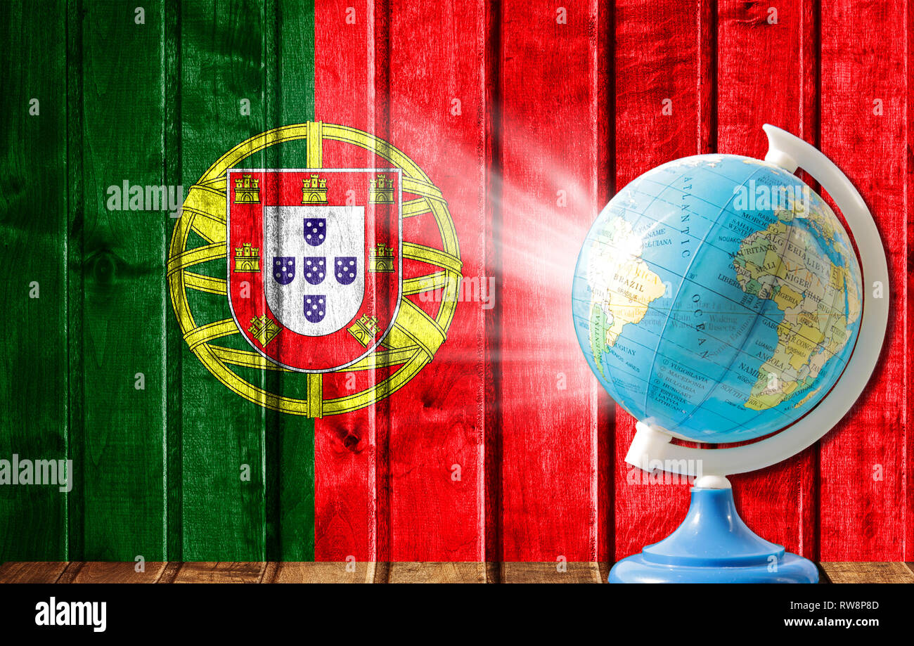 Globe with a world map on a wooden background with the image of the ...