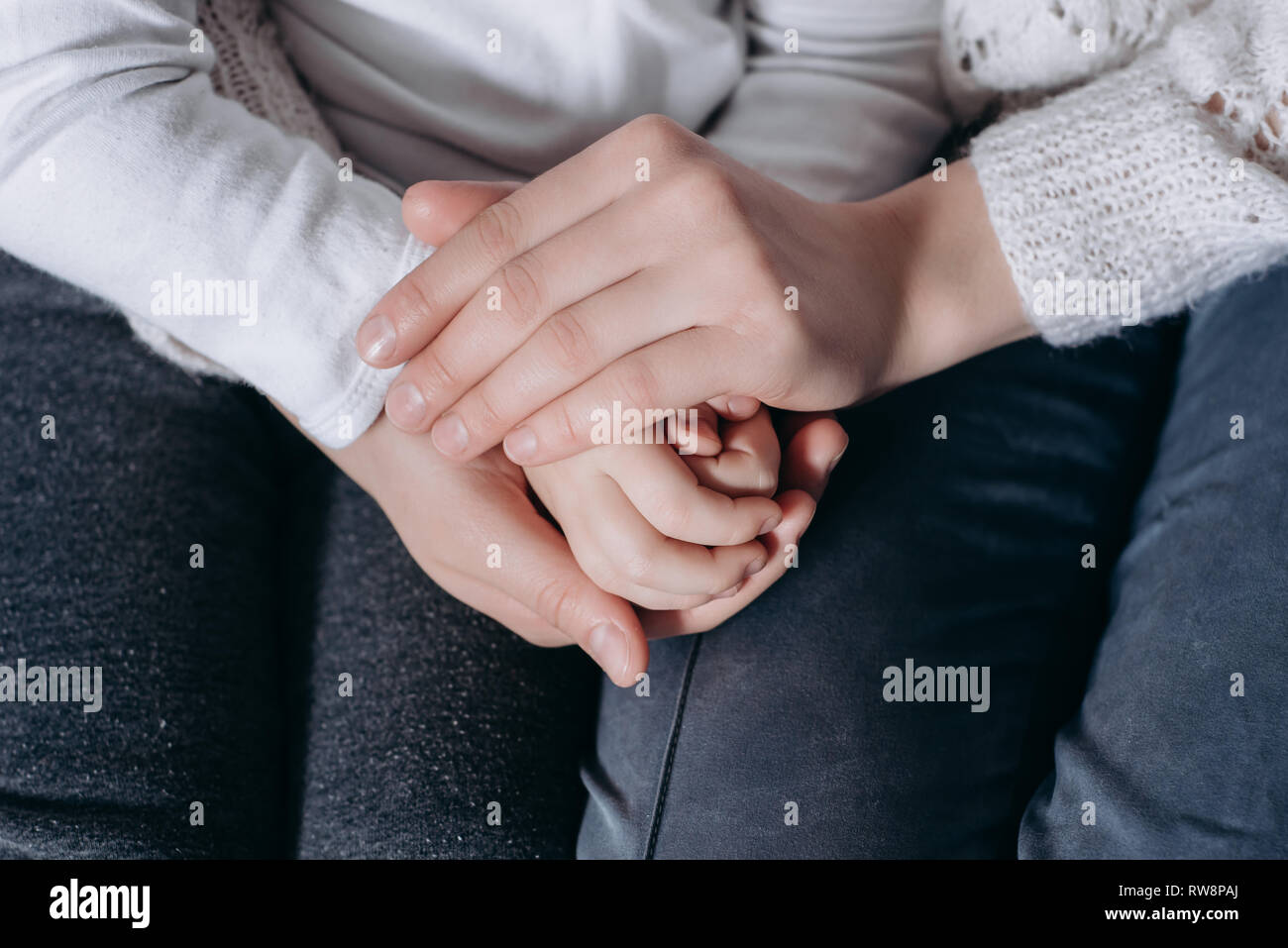 Close up view of family holding hands, loving caring mother supporting ...