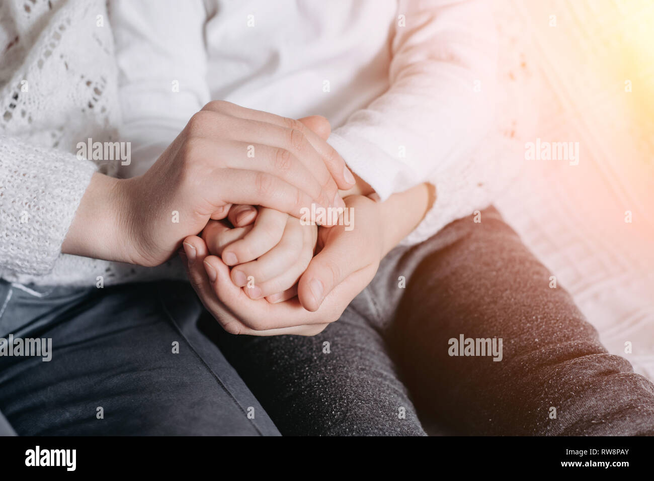 Close up view of family holding hands, loving caring mother supporting ...