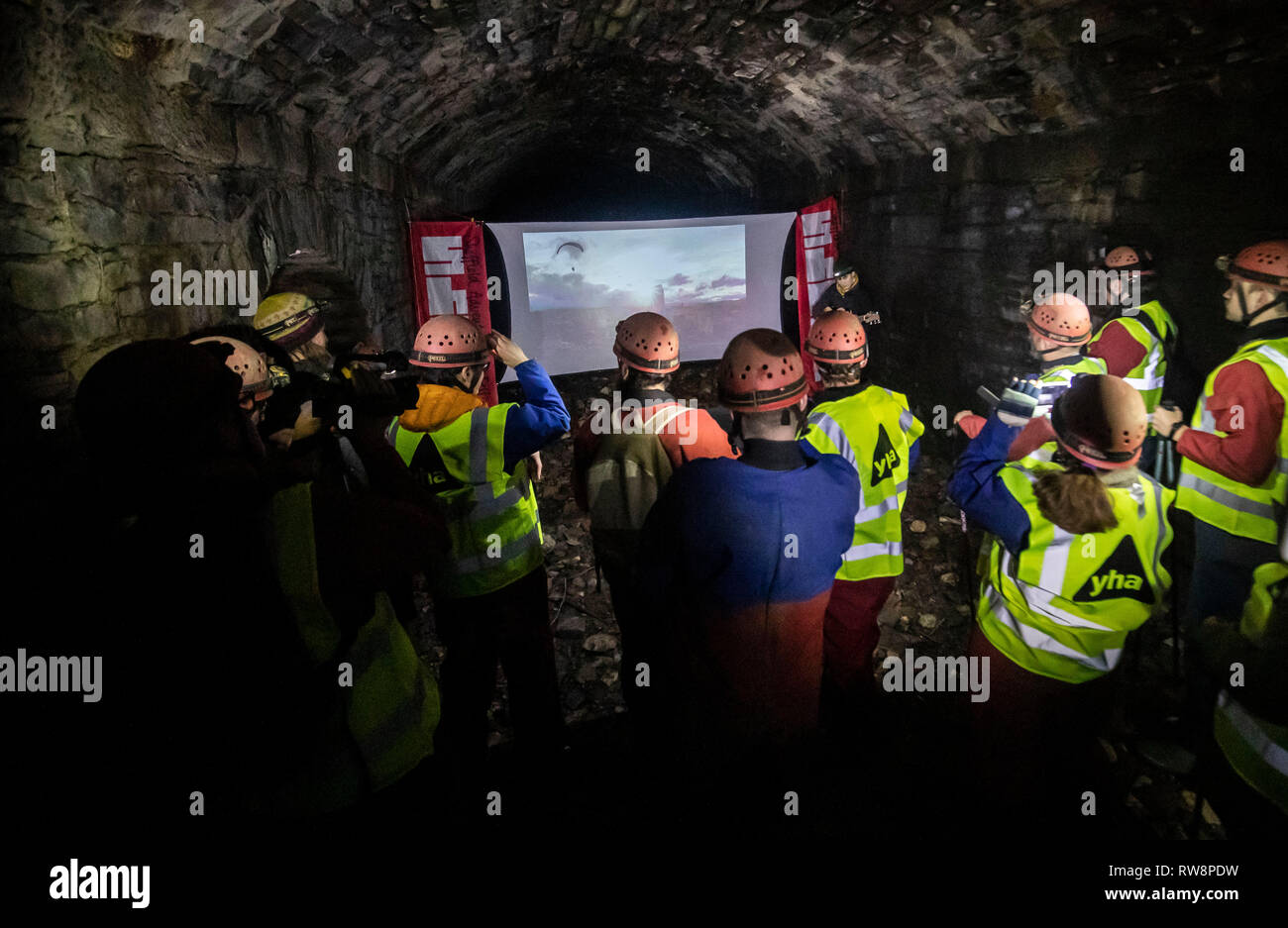 People watch a film while Urban Caving as an underground network of ...
