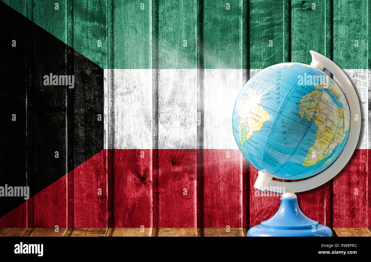 Globe with a world map on a wooden background with the image of the ...