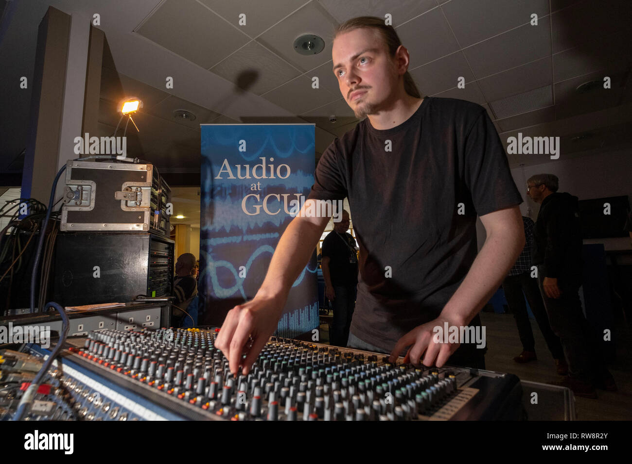 Sound Engineers working at mixing desk Stock Photo - Alamy