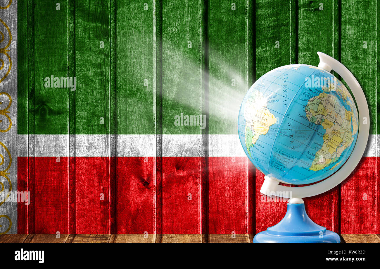 Globe with a world map on a wooden background with the image of the ...