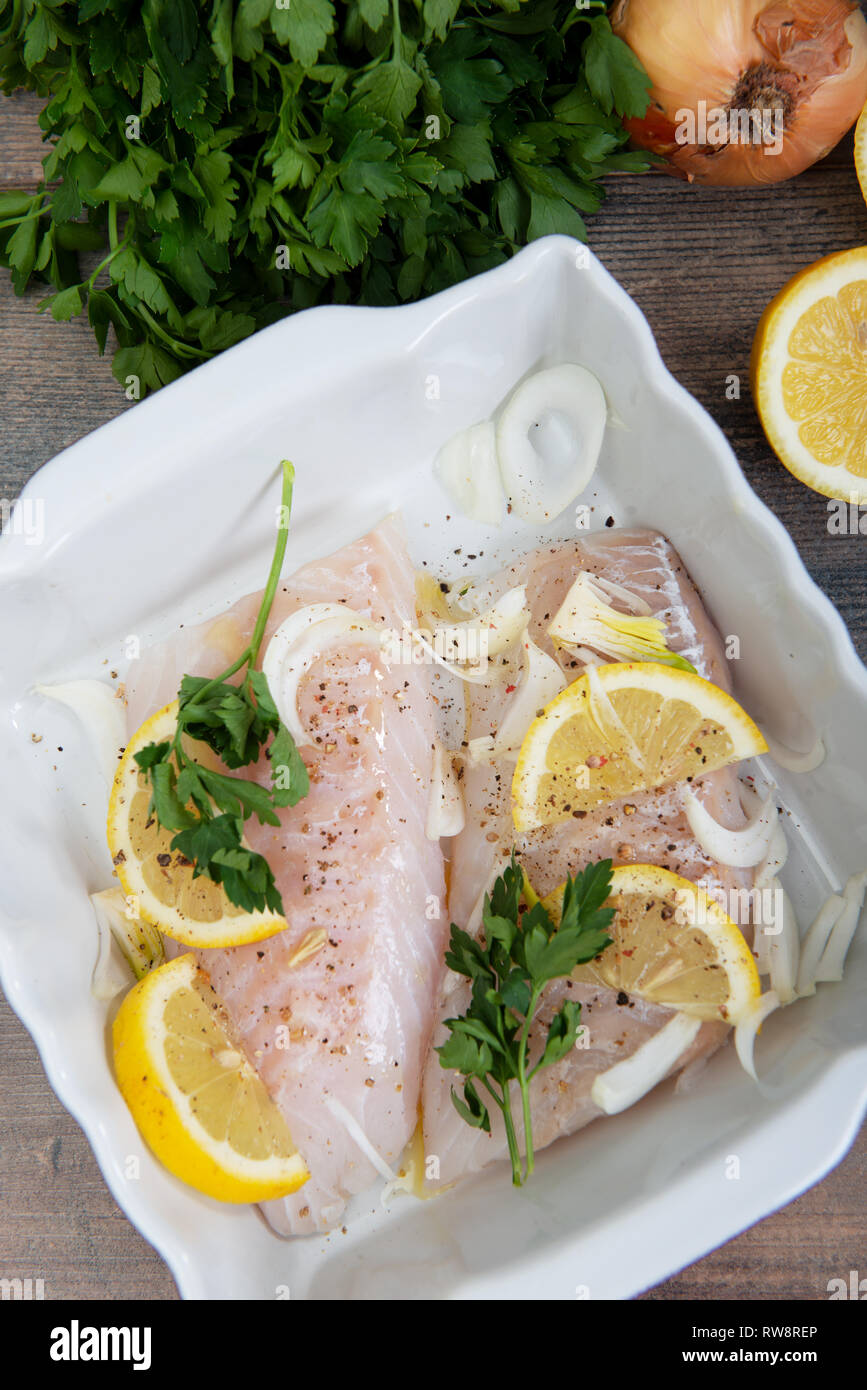 Fresh fish, a raw cod fillets with addition of herbs and lemon Stock ...