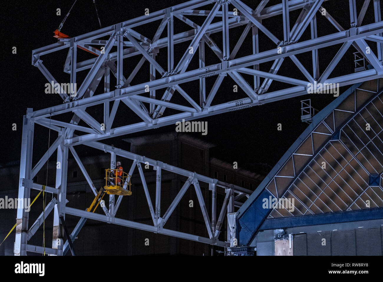 Evening crane lift of major steel work hi-res stock photography and ...