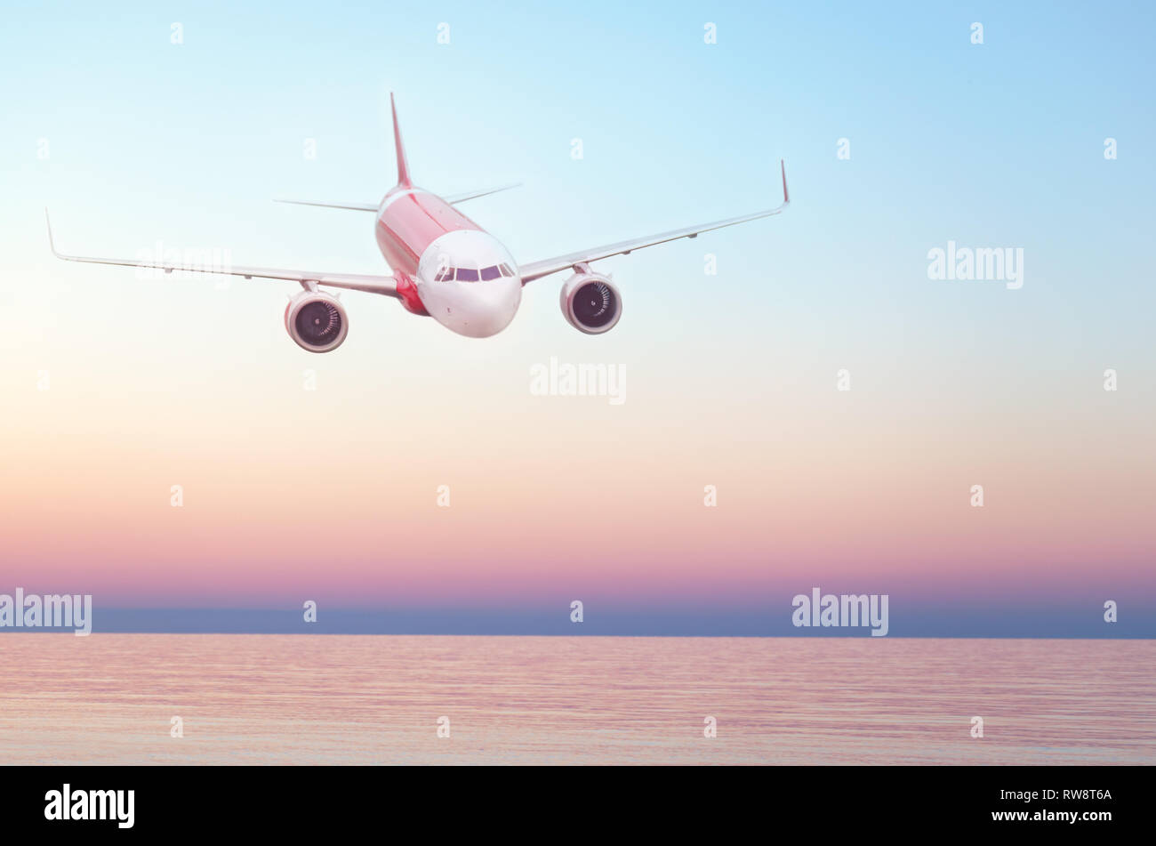 Airplane In Sky Sunset Over Ocean High Resolution Stock Photography and ...