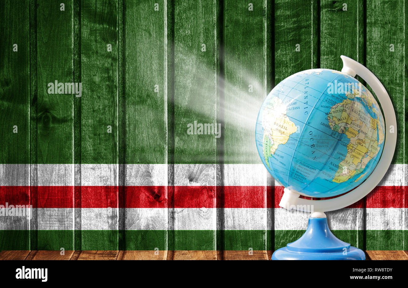 Globe with a world map on a wooden background with the image of the ...