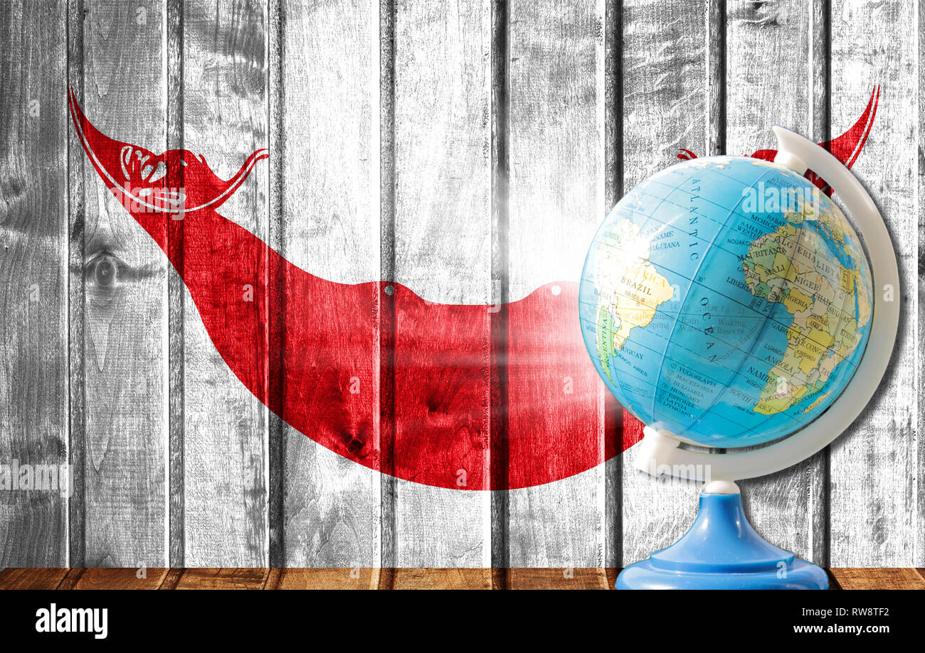Globe with a world map on a wooden background with the image of the ...