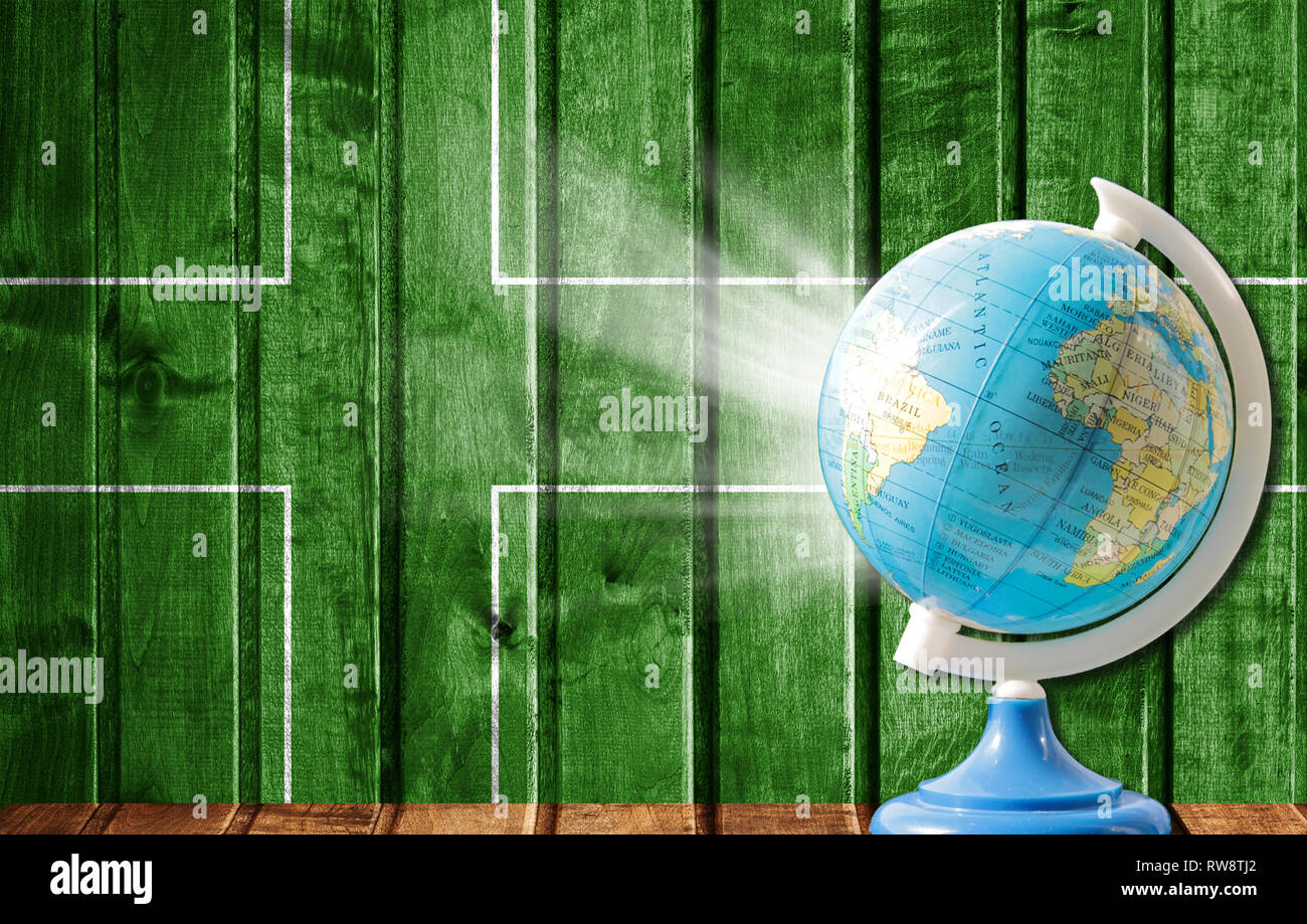 Globe with a world map on a wooden background with the image of the ...