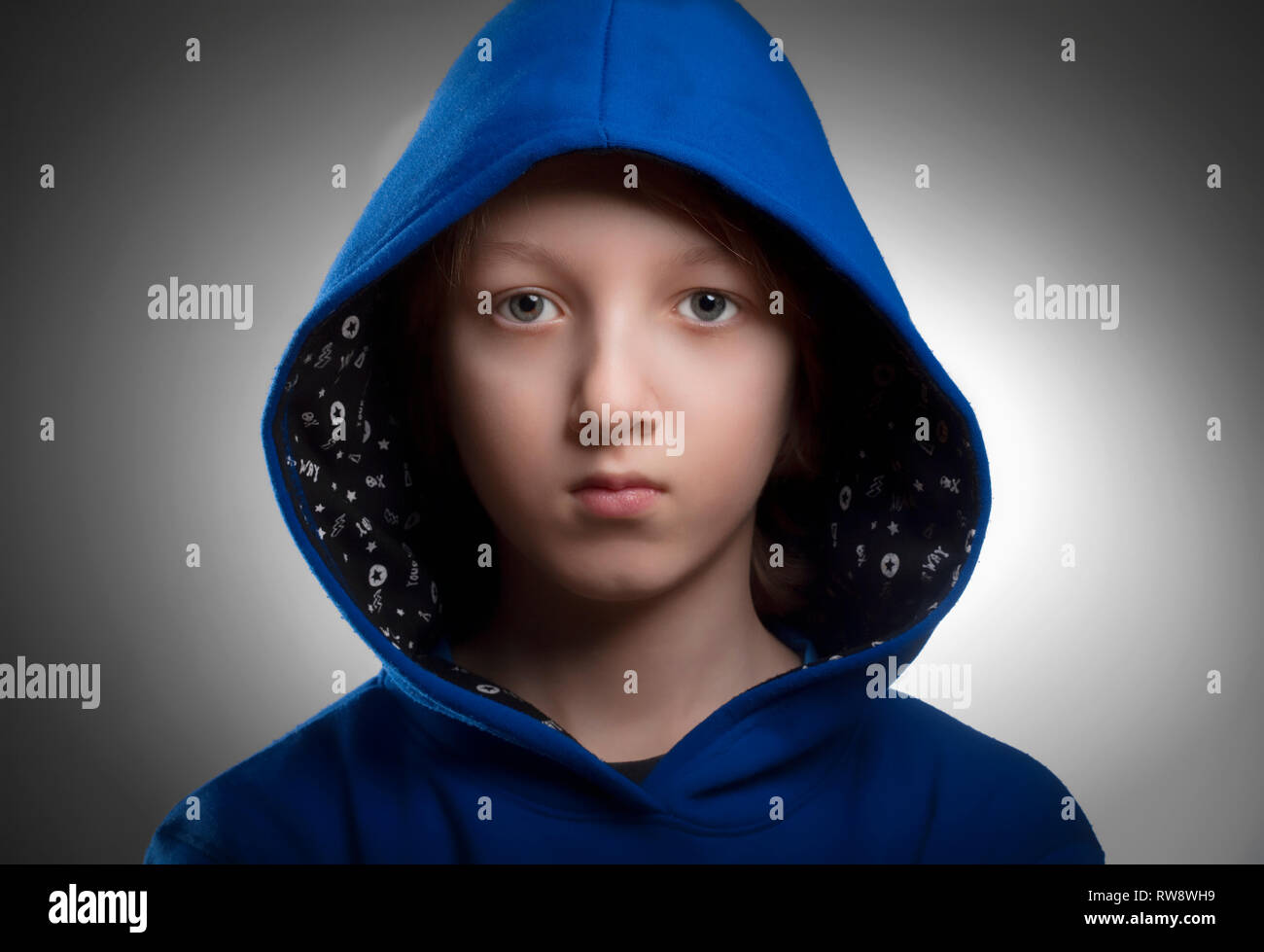 Portrait of a Boy with Brown Hair in Blue Hood Stock Photo - Alamy