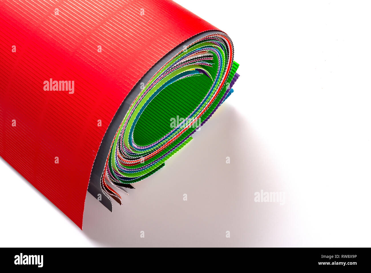 multi color cardboard corrugated papers rolled up on white Stock Photo ...