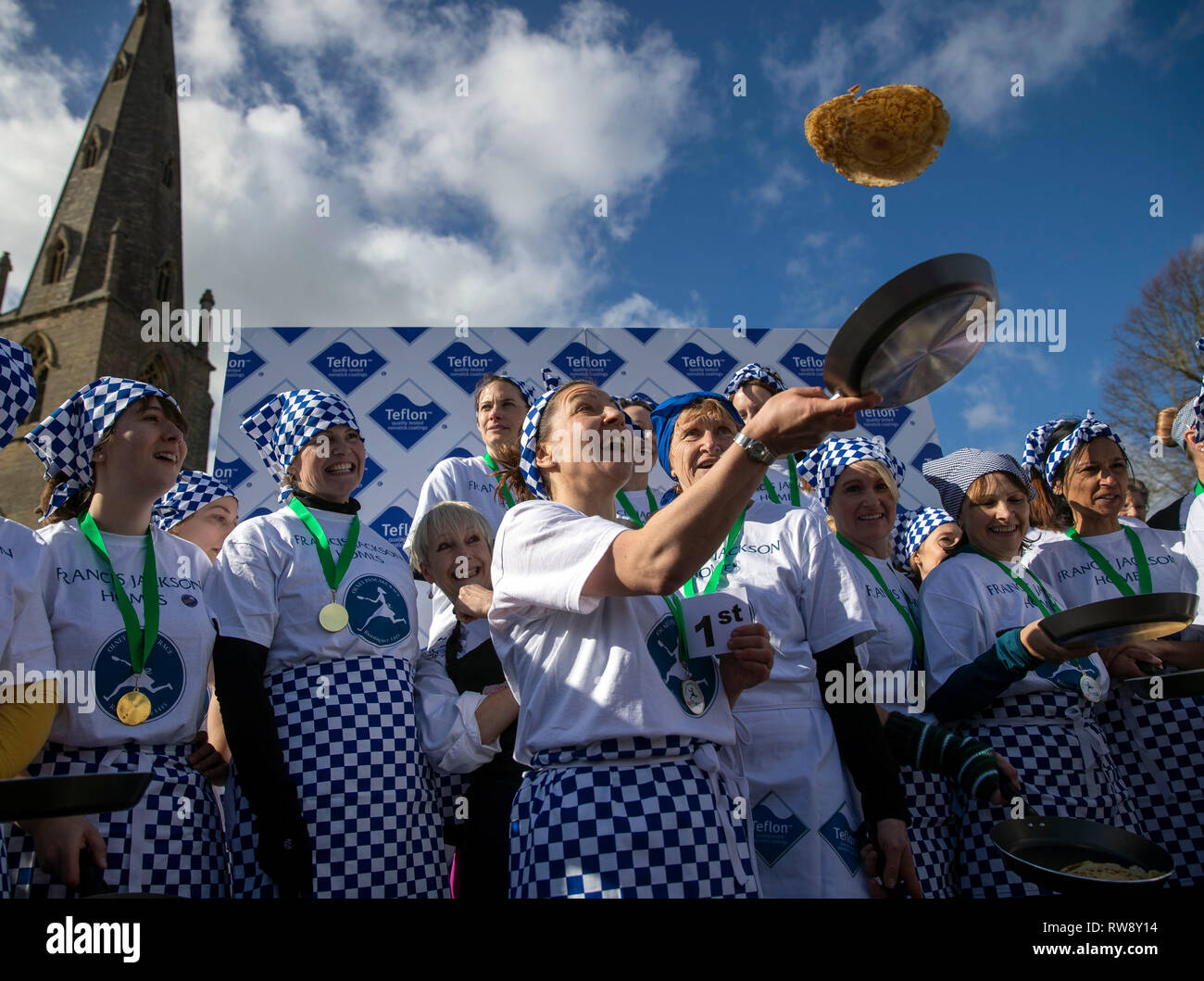 Amy Butler (centre) flips her pancake after winning the annual Pancake ...