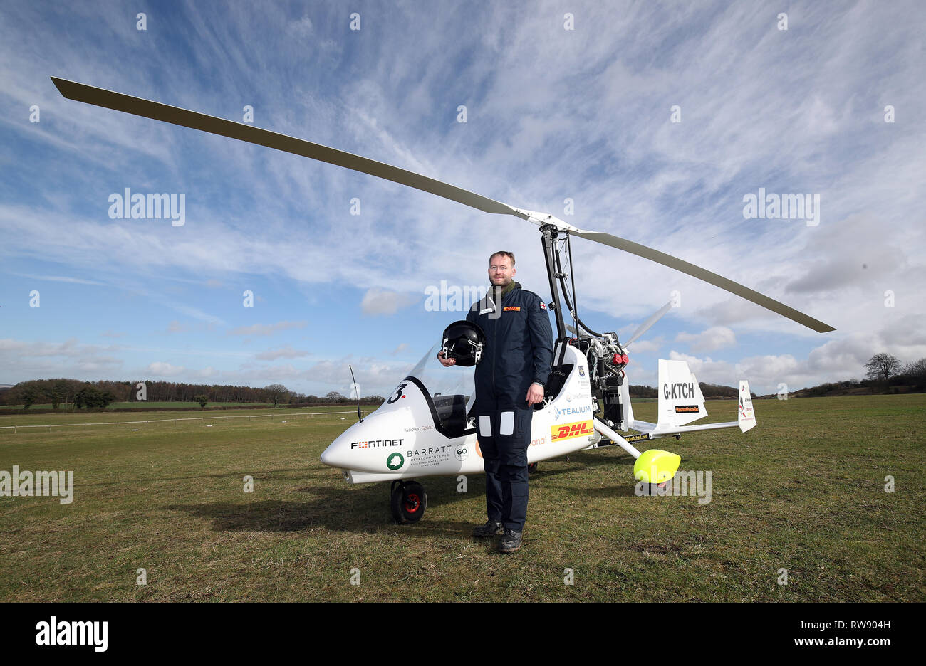 British adventurer James Ketchell next to his open cockpit gyrocopter ...