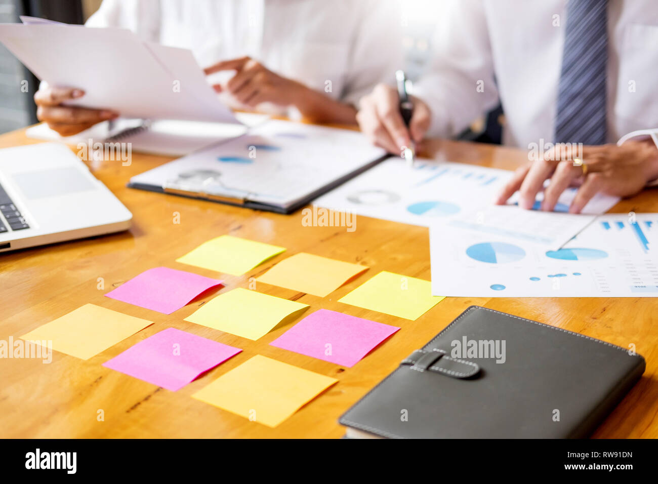 Business team data analyzing income charts document during discussion ...