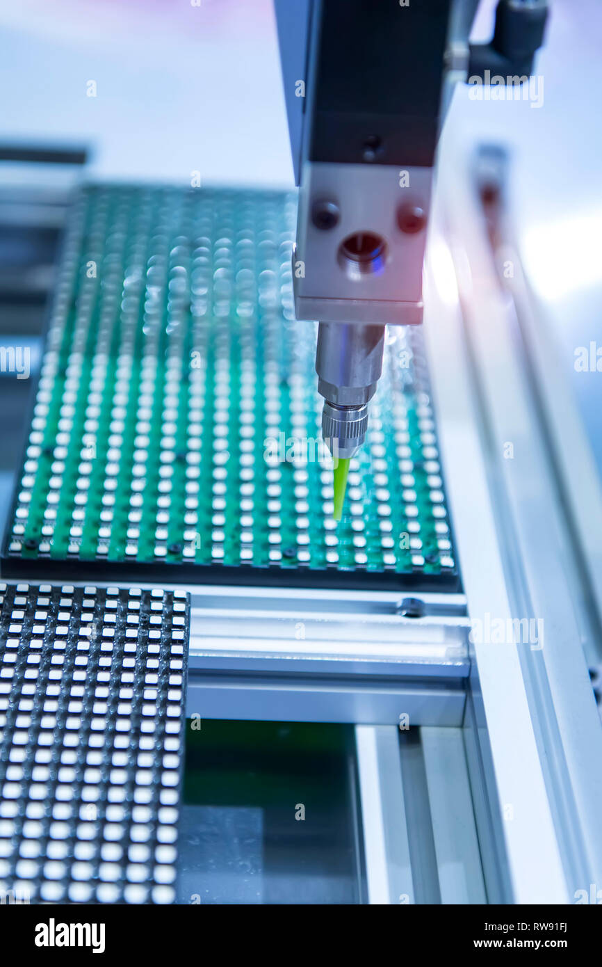 Robot holding glue syringe Injection in factory Stock Photo - Alamy